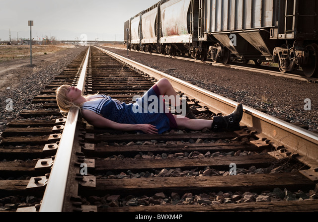 damsel in distress lays on railroad tracks in the american west Stock ...